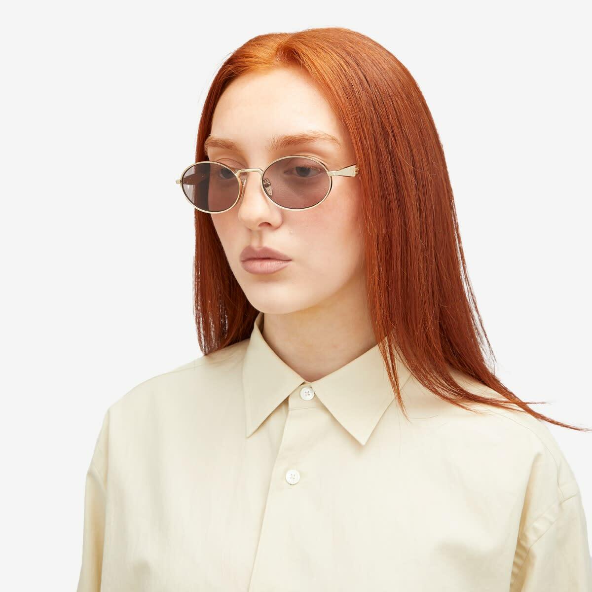 Prada Eyewear 65ZS Sunglasses in Pale Gold/Light Purple Prada