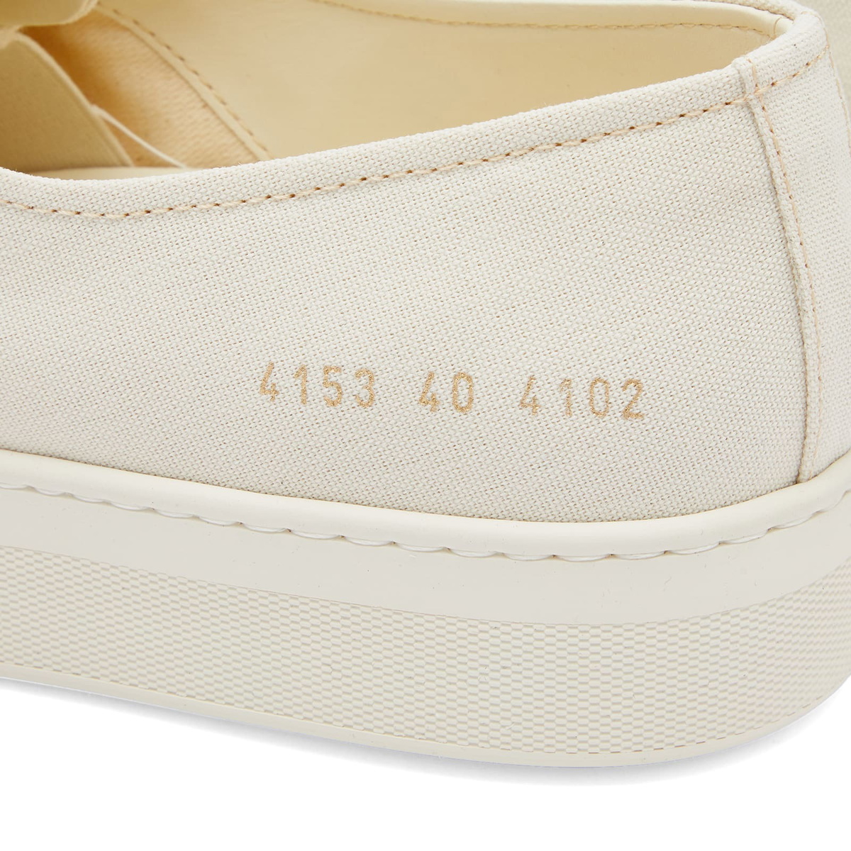 Woman by Common Projects Women's Four Hole Canvas Sneakers in Off White ...